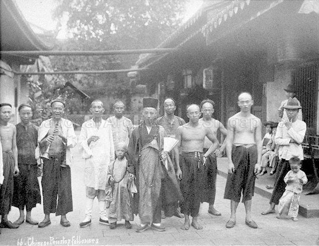 Chinese priest and his attendants in the courtyard of Thian