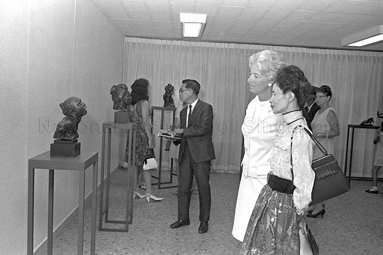 VISITORS ATTENDING THE EXHIBITION ON RODIN AND HIS
