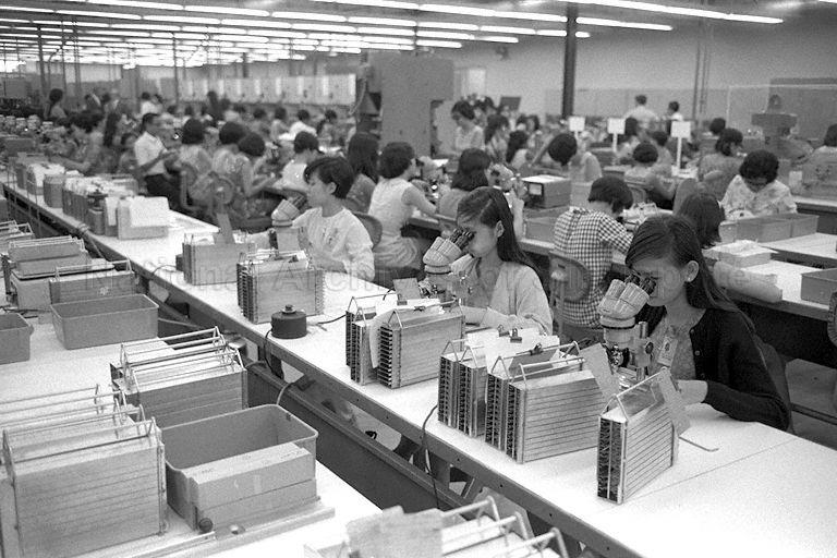 WORKERS AT WORK IN FACTORY OF TEXAS INSTRUMENTS (PTE) LTD AT