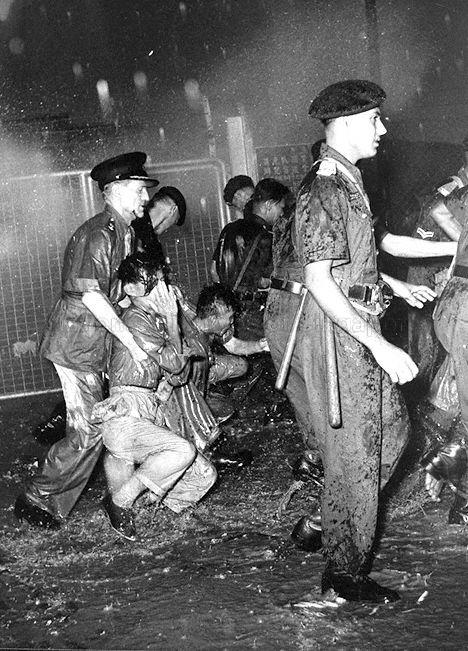 RIOT POLICE ATTENDING TO INJURED VICTIMS AT HOCK LEE BUS