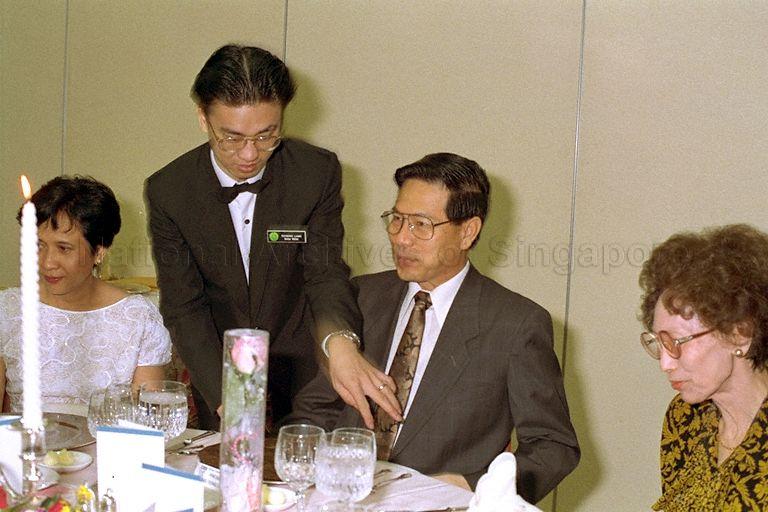 A server attending to President Ong Teng Cheong during the