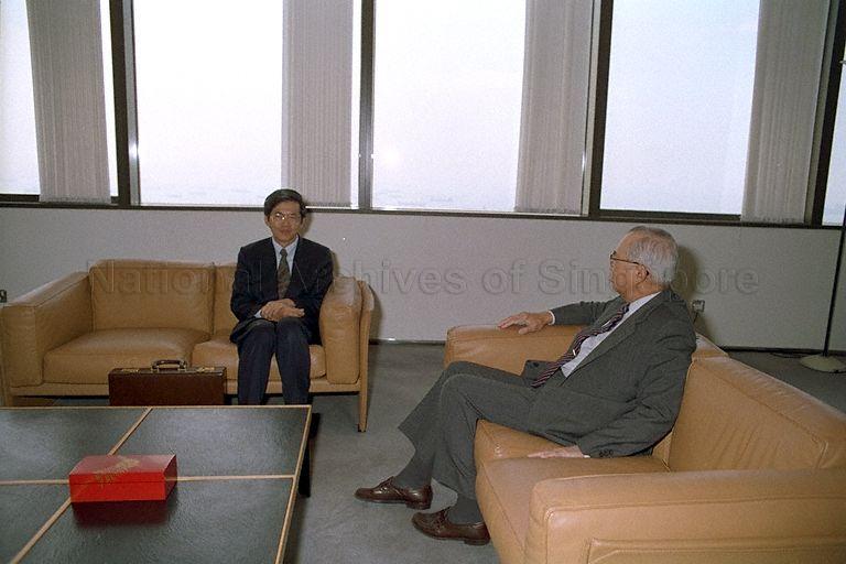 Minister for Finance, Dr Richard Hu (right) talking with