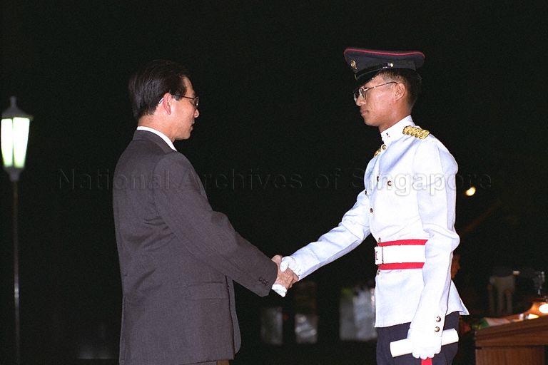 President's scholar Ong Tze Ch'in receiving the President's