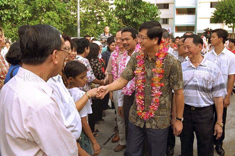 Minister without Portfolio Lim Boon Heng (garlanded, front)