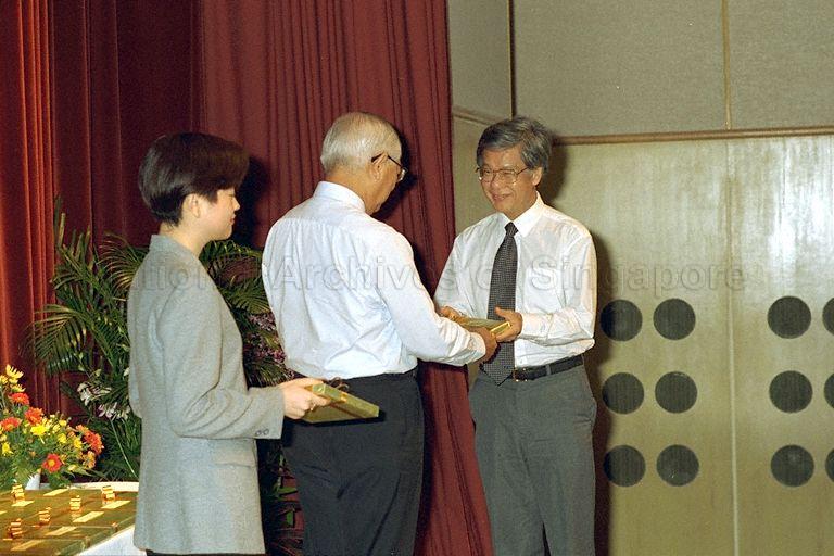 Minister for Finance Dr Richard Hu Tsu Tau (left) presenting