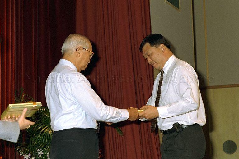 Minister for Finance Dr Richard Hu Tsu Tau (left) presenting