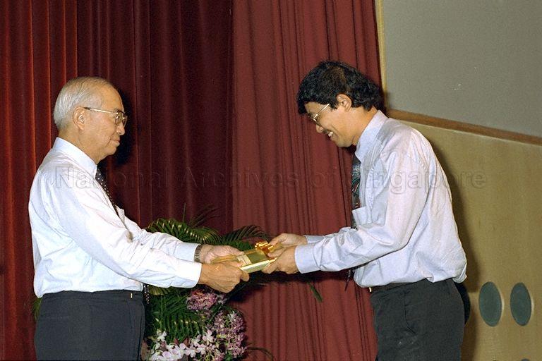 Minister for Finance Dr Richard Hu Tsu Tau (left) presenting