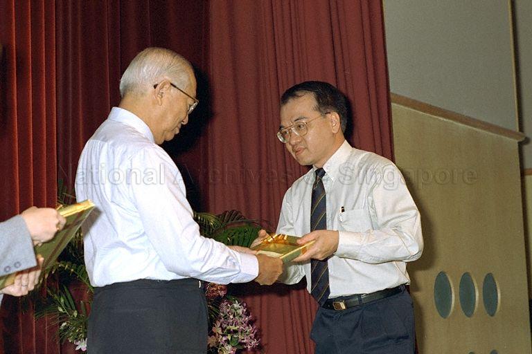 Minister for Finance Dr Richard Hu Tsu Tau (left) presenting