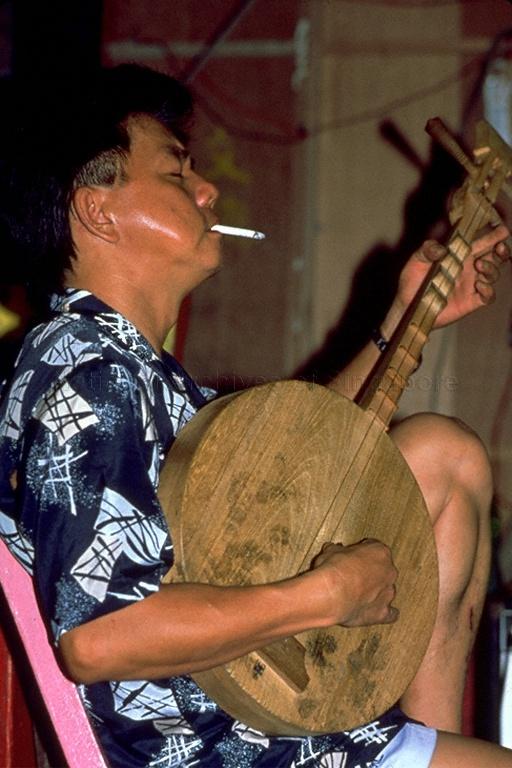 View of Chinese wayang (opera) musician playing the 'ruan'