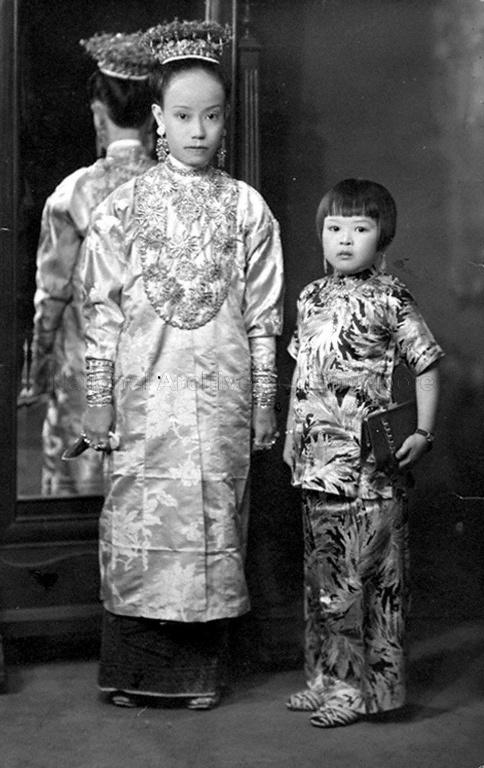 Studio shot of a Straits Chinese bride and a young girl in