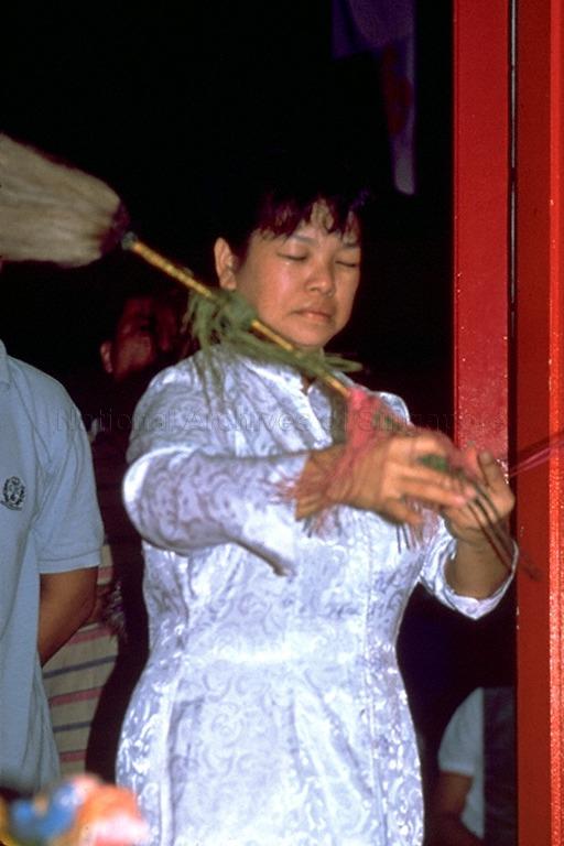 Medium (tangki) with whip (fashan) performing ritual at a