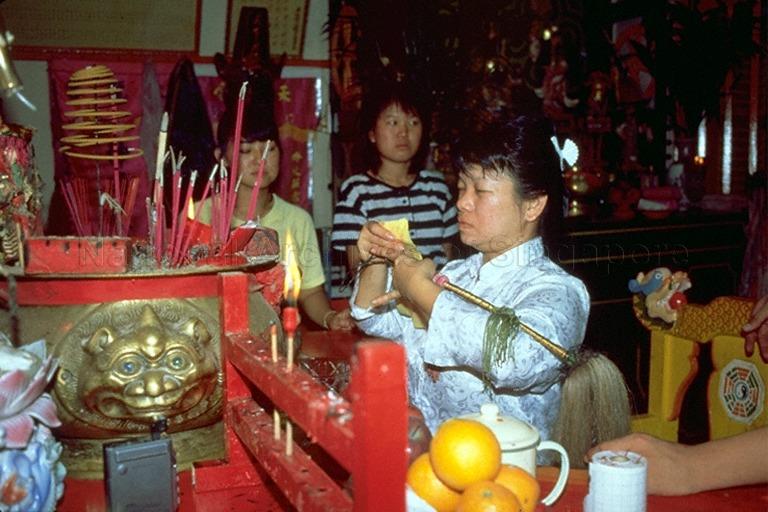 Medium (tangki) performing ritual at a Taoist temple