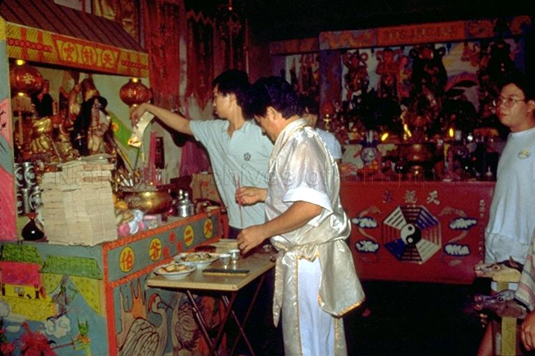 Medium (tangki) performing ritual at Taoist temple