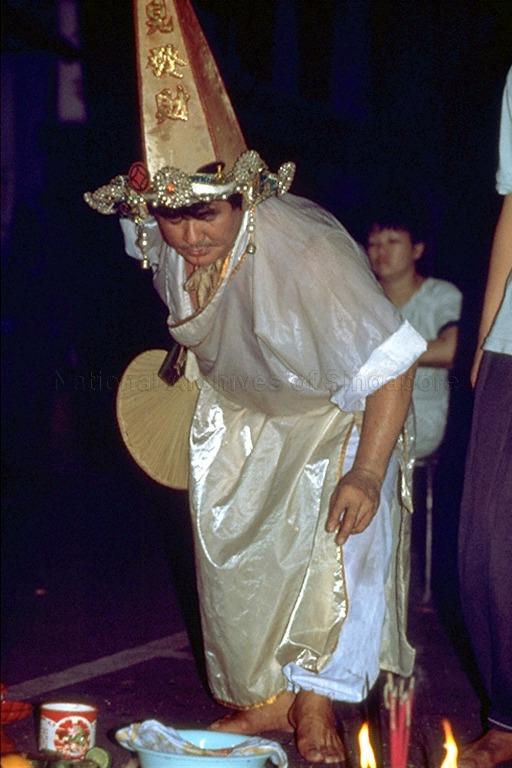Medium (tangki) performing ritual at Taoist temple