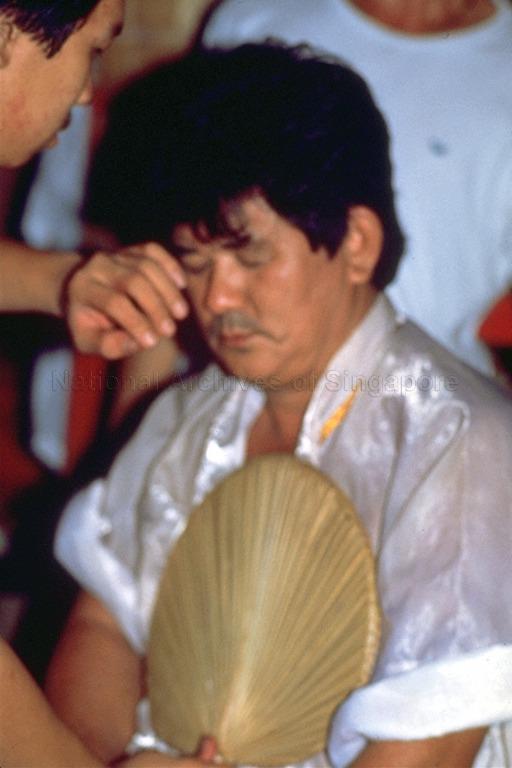 Medium (tangki) in a trance during ritual at Taoist temple