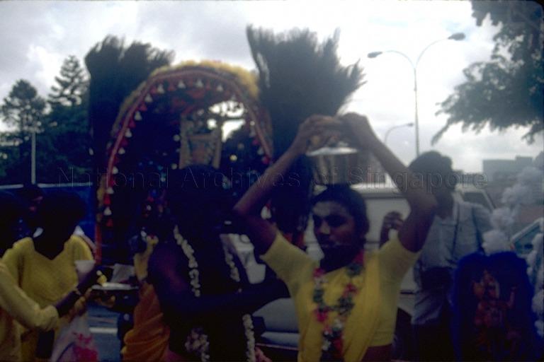 Devotees carrying kavadi and milk pot during Thaipusam