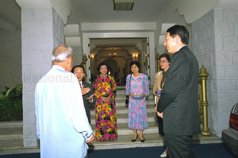 Sultan Mahmood Iskandar of Johor (left, back to camera) and