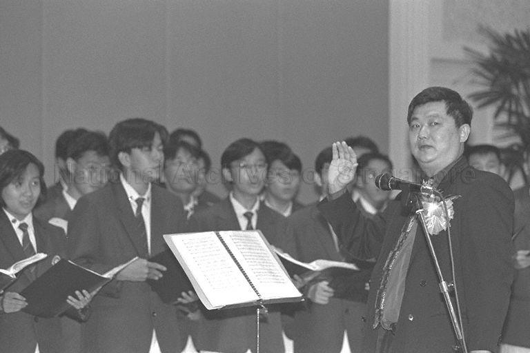 Award recipient Nelson Kwei (right) conducting the choir