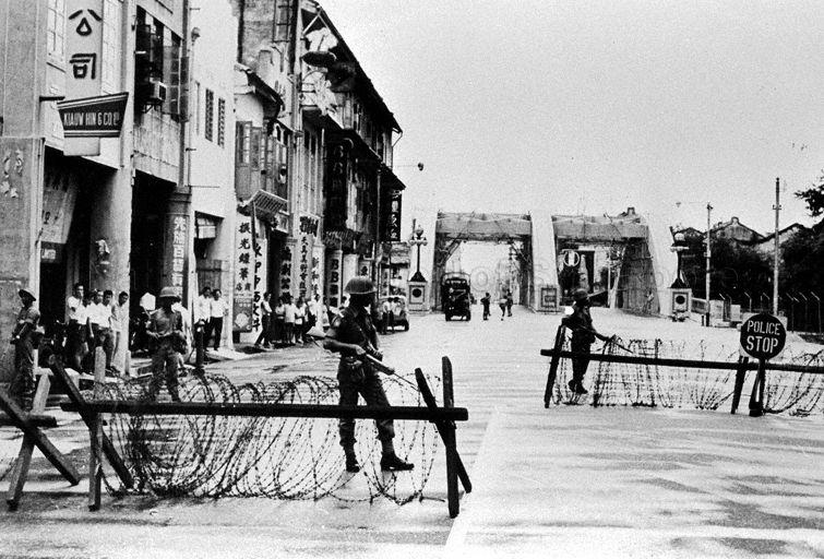 ROAD BLOCK SET UP BY POLICE AND SOLDIERS AFTER A RACIAL RIOT