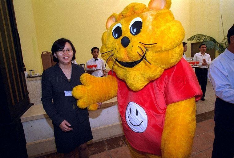 Official posing for photograph with Singa the Courtesy Lion