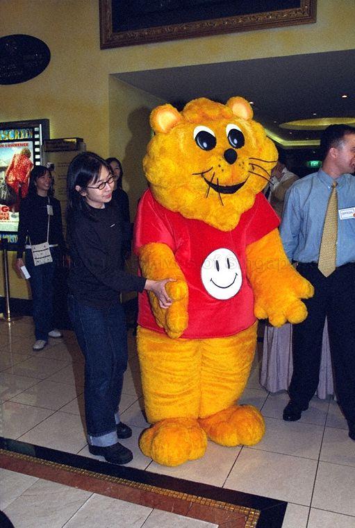 Officials posing for photograph with Singa the Courtesy Lion