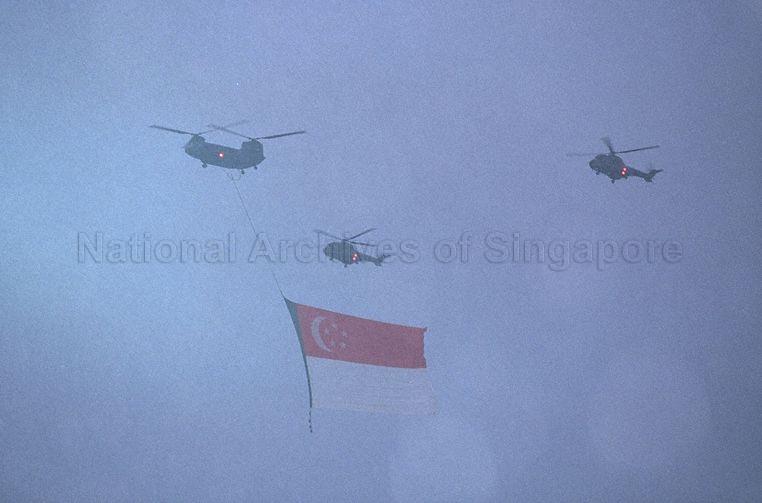 Helicopter fly-past with national flag at Singapore Armed