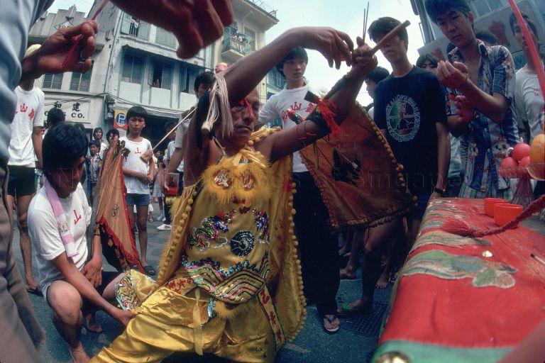 Medium in trance during a procession performing a ritual at