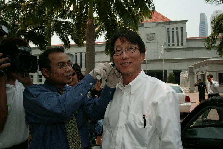 Minister for the Environment Lim Swee Say having his