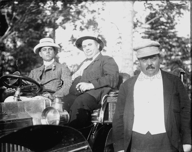 Charles Jasper Glidden (left) posing by his motor car, a