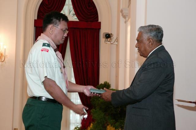 President and Singapore's Chief Scout S R Nathan presenting