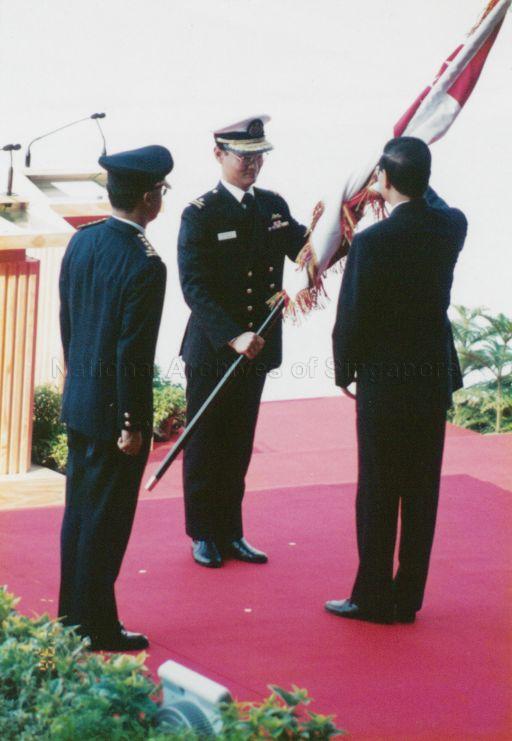 PRESIDENT ONG TENG CHEONG (RIGHT) PRESENTING STATE COLOURS