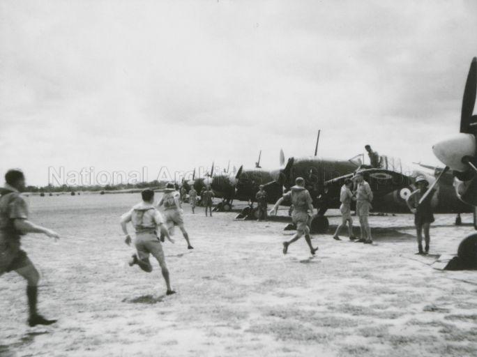 SEMBAWANG, SINGAPORE. PILOTS OF NO. 453 SQUADRON RAAF RUN TO