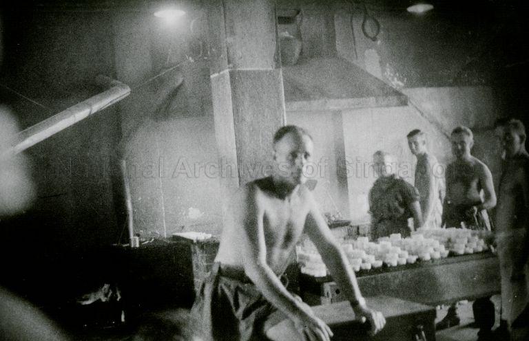 Allied prisoners of war (POWs) working in cookhouse at