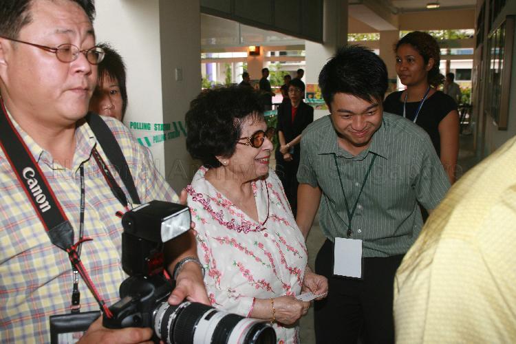Mrs S R Nathan chatting with official. She and President S R