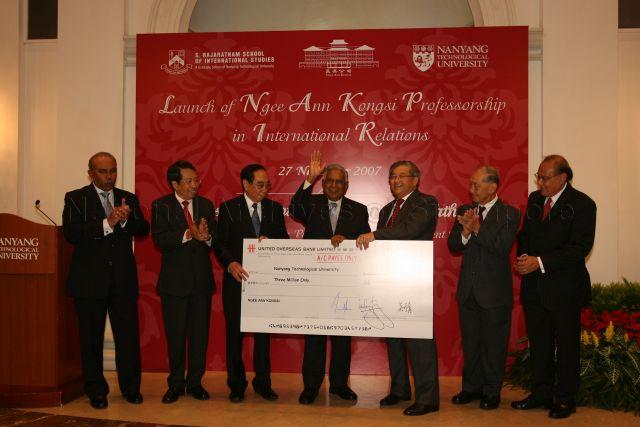 Guest of honour, President S R Nathan holding the cheque of