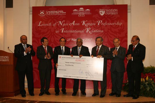 Guest of honour, President S R Nathan holding the cheque of