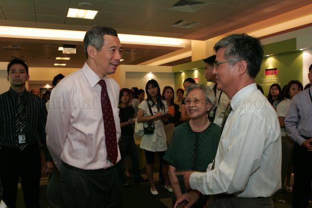 Prime Minister Lee Hsien Loong speaking to Mr D J Tan,