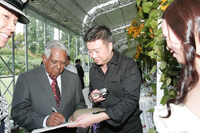 President S R Nathan signing autograph for guest during