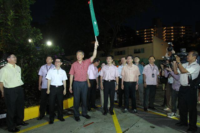 Prime Minister Lee Hsien Loong flagging off trucks making