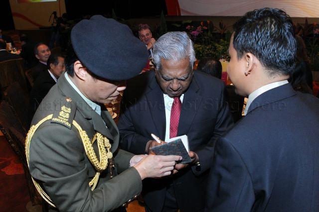 President S R Nathan signing an autograph during the