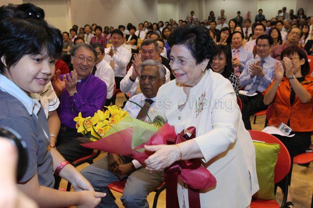 Mrs S R Nathan, wife of the President, being presented with
