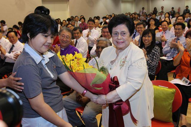 Mrs S R Nathan, wife of the President, being presented with