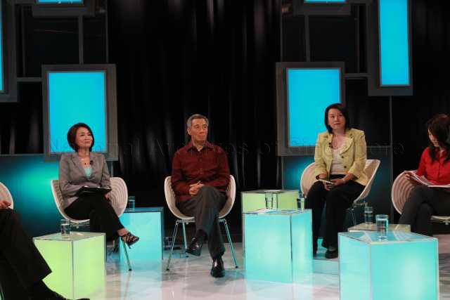 Prime Minister Lee Hsien Loong, flanked by MediaCorp current