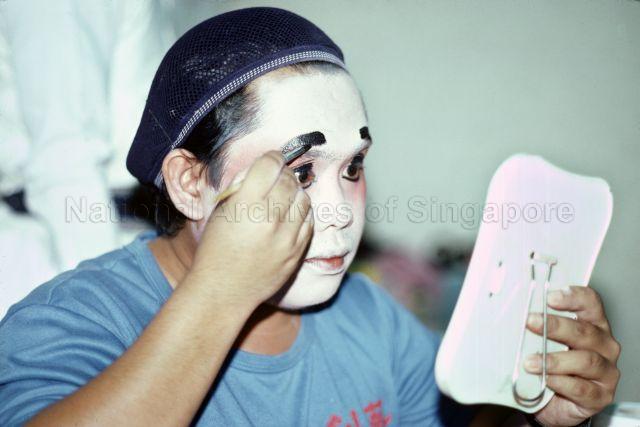 Opera actor putting on stage makeup