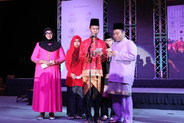 A group of Malays in traditional clothes on stage during