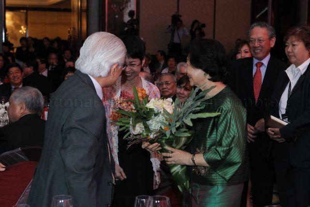 First Lady Mrs Mary Tan is presented with a bouquet of