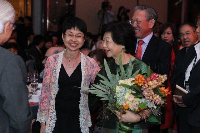 First Lady Mrs Mary Tan is presented with a bouquet of