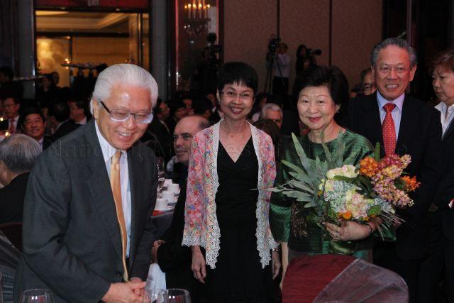 First Lady Mrs Mary Tan is presented with a bouquet of