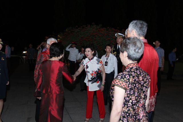 First Lady Mrs Mary Tan (left, back facing camera) is