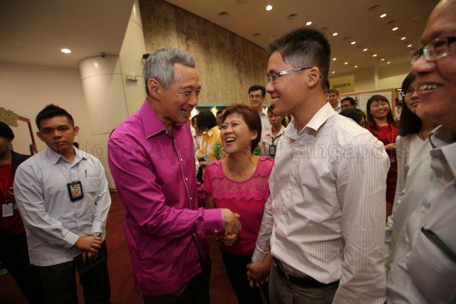 Prime Minister Lee Hsien Loong with Mrs Lim, who manages a